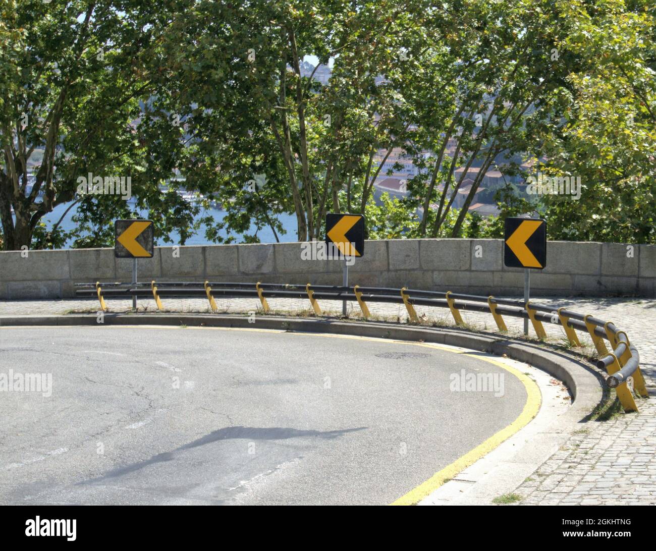 Twisting highway road with left directional signs Stock Photo - Alamy