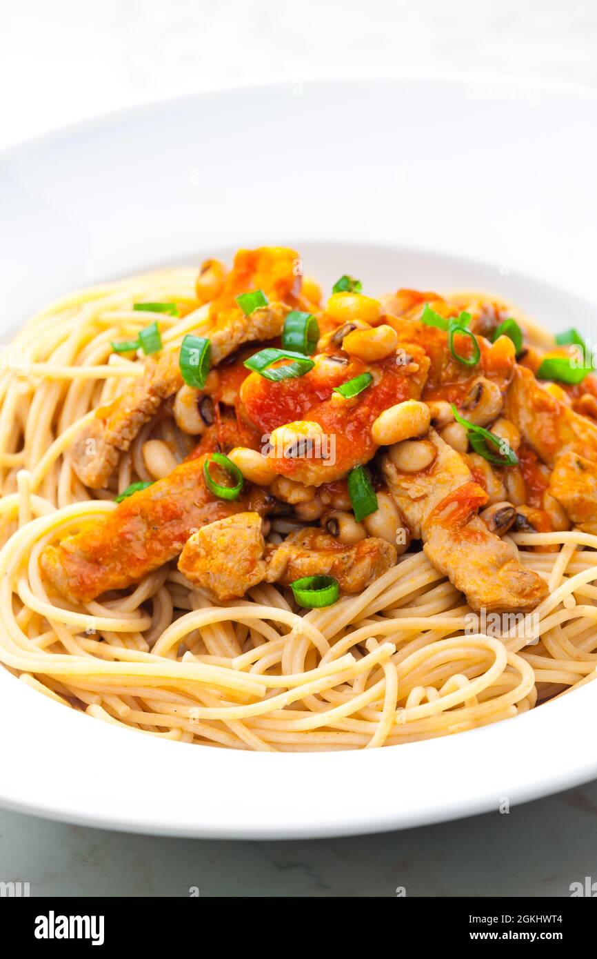 spaghetti with poultry meat, tomato sauce and beans Stock Photo - Alamy