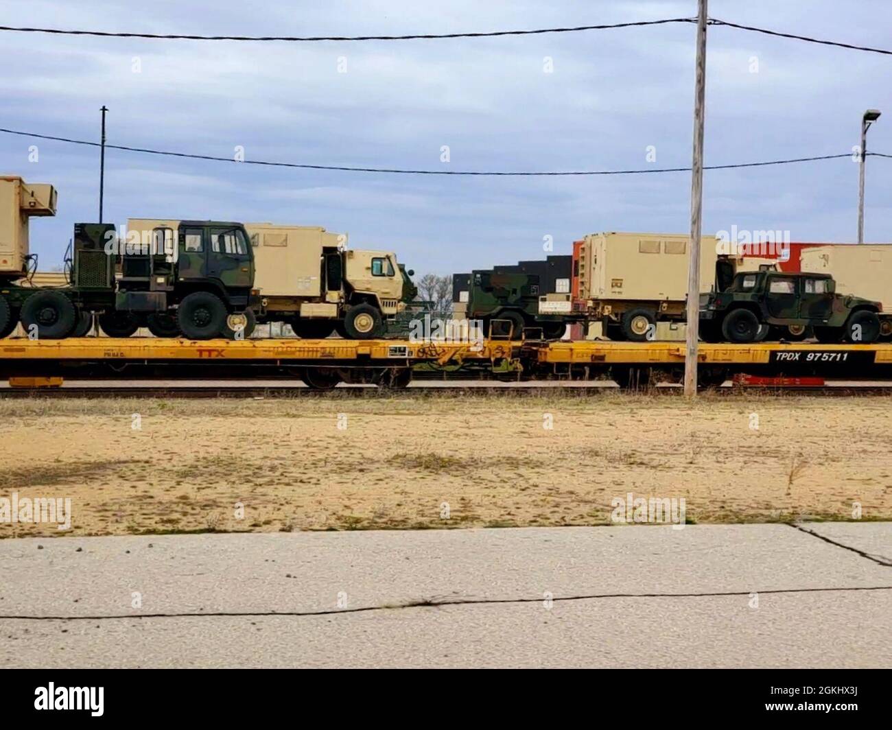 Equipment belonging to a deploying Army unit is shown on railcars as ...
