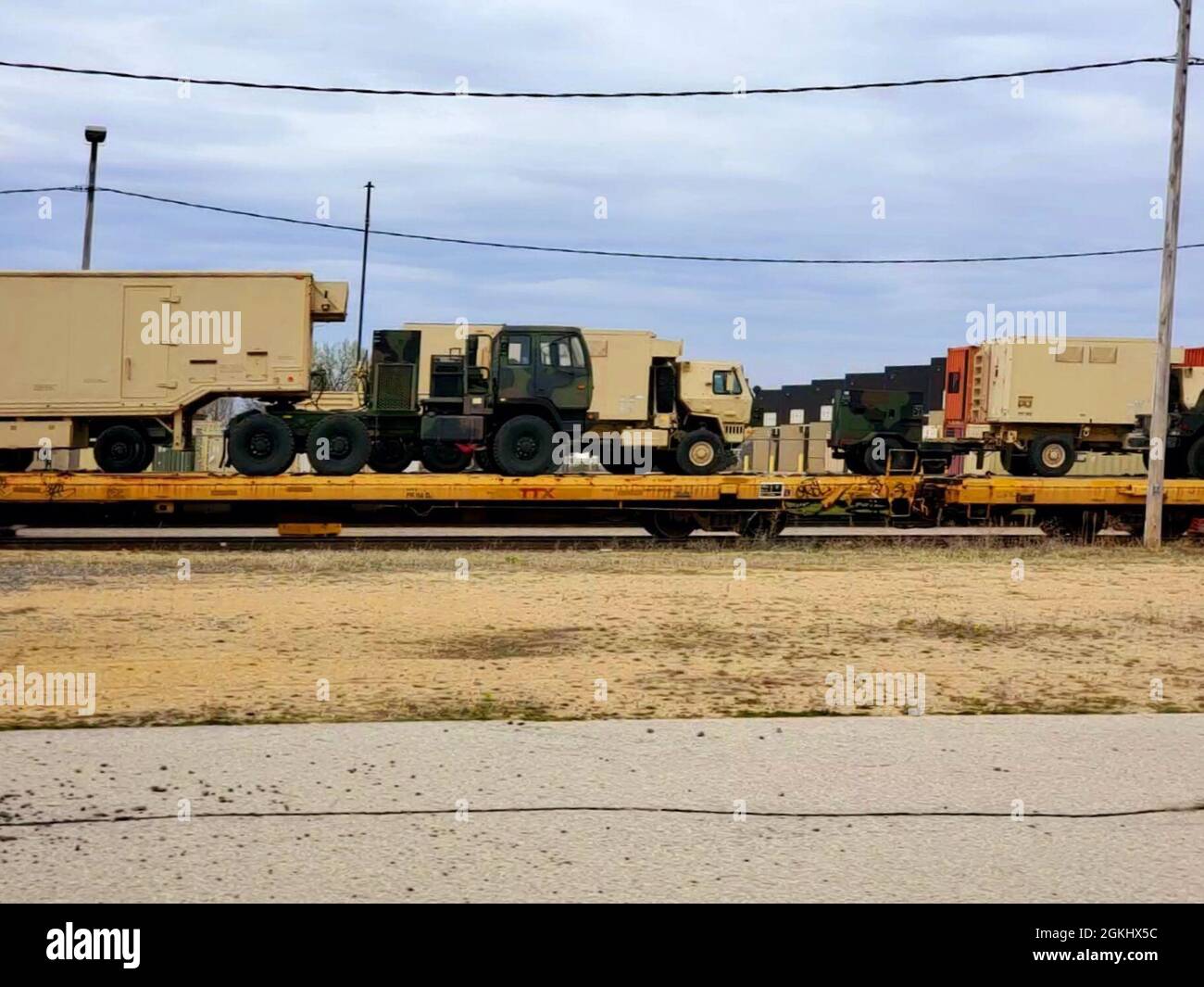 Equipment belonging to a deploying Army unit is shown on railcars as ...