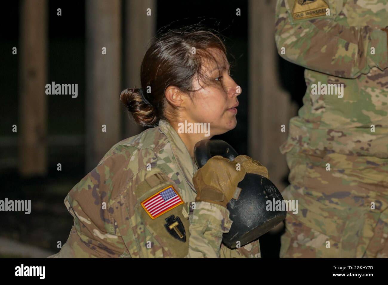 A Soldier with 303rd Military Intelligence Battalion performs squats ...