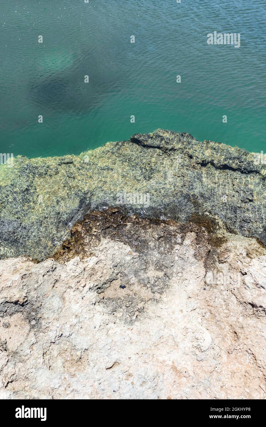 View of mossy water and rocky seashore from the top of a cliff Stock ...