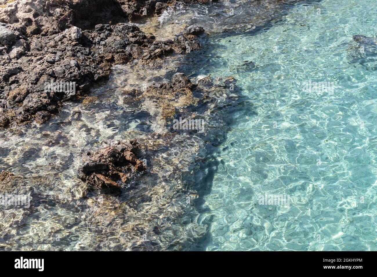View of mossy water and rocky seashore from the top of a cliff Stock ...