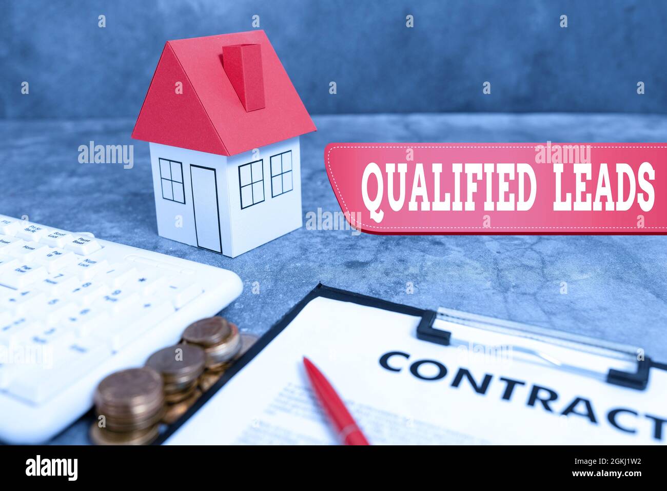 Hand writing sign Qualified Leads. Word Written on lead judged likely ...