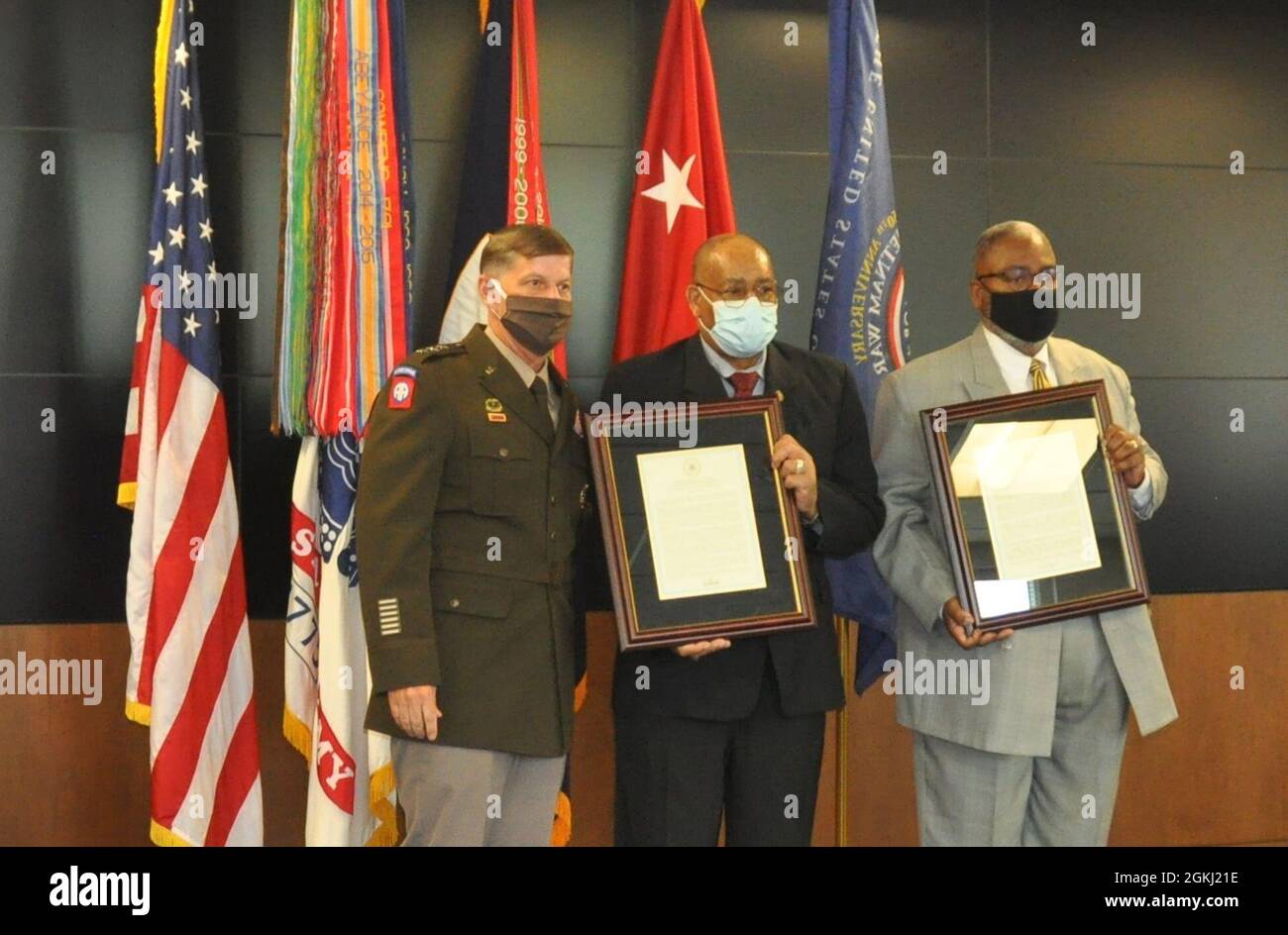 Vietnam veterans Burnie Coats, center, and David Lewis receive plaques ...