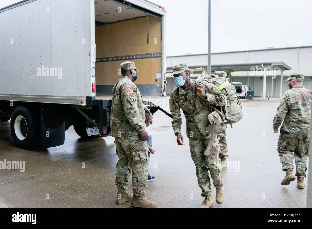 Soldiers of the 1st Theater Sustainment Command remove equipment from a ...