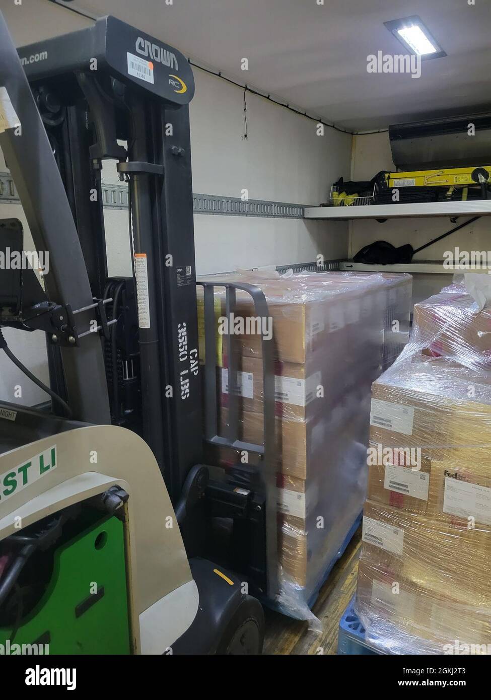 A forklift truck unloads flu vaccines destined for warfighters serving ...
