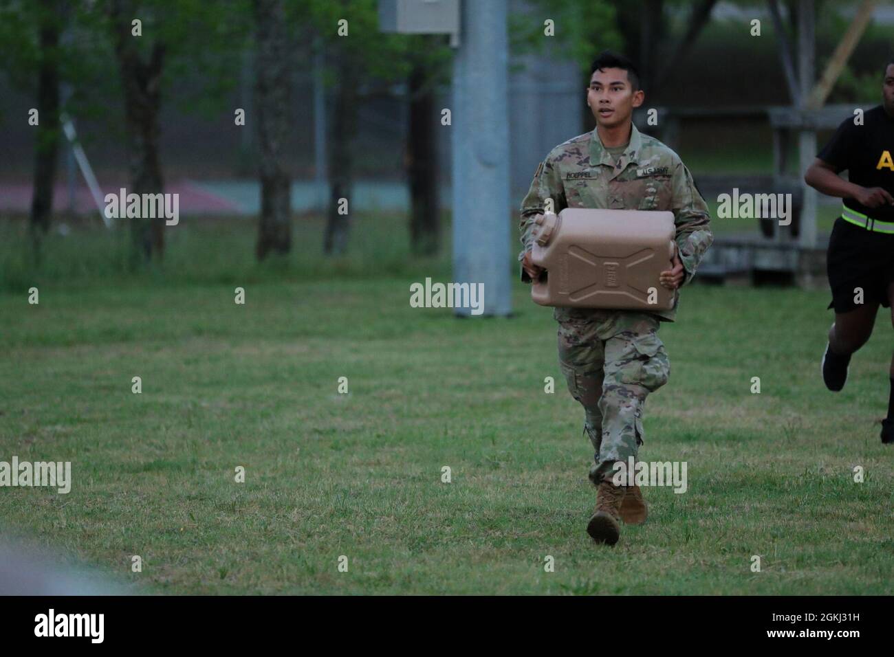 A Soldier with 303rd Military Intelligence Battalion carries a full ...