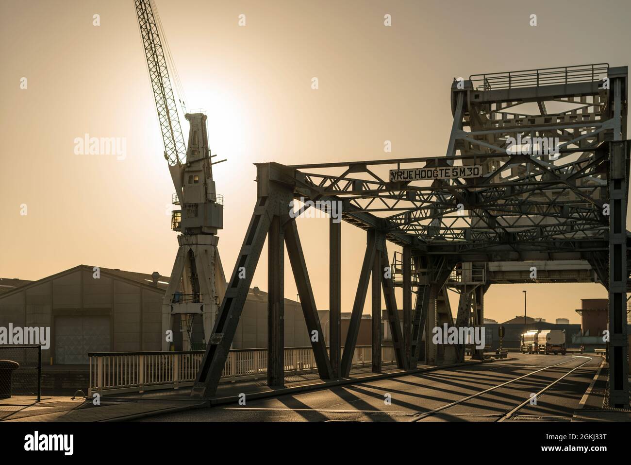 Industrial metal bridge, maritime cranes, warehouses and road in the ...