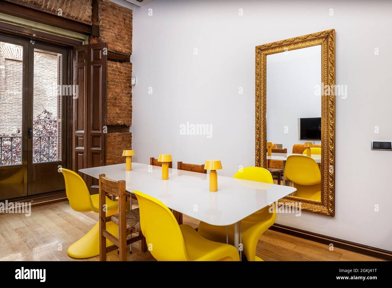 Dining table in dining room with lots of yellow accents and large gold ...