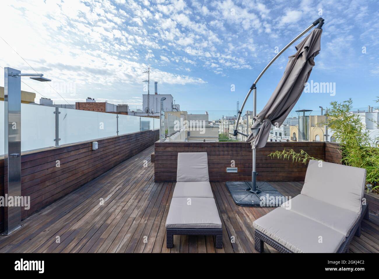 Attic terrace with hammocks, parasol, shower and wooden slatted floors ...