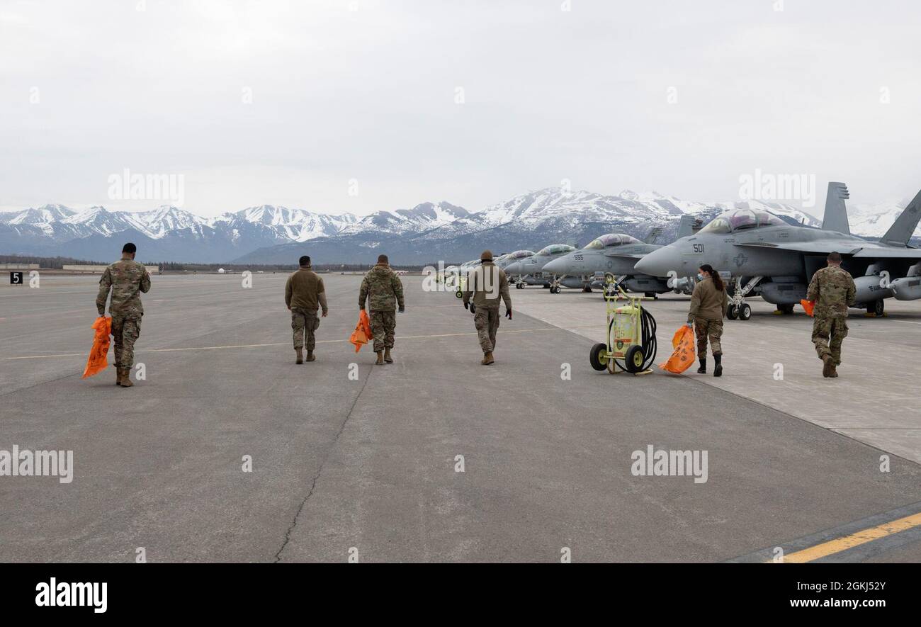 Airmen assigned to the 3rd Wing conduct a foreign object debris walk on ...