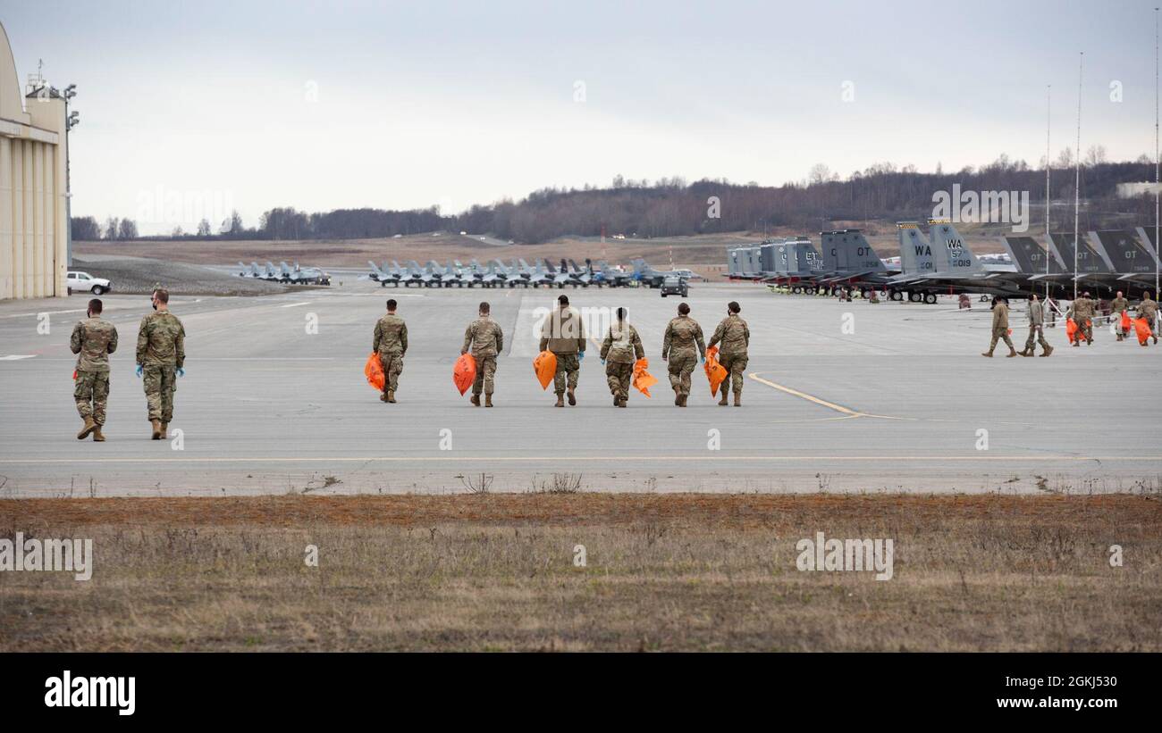 Airmen assigned to the 3rd Wing conduct a foreign object debris walk on ...
