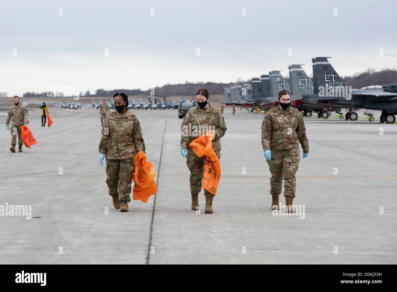 Airmen assigned to the 3rd Wing conduct a foreign object debris walk on ...