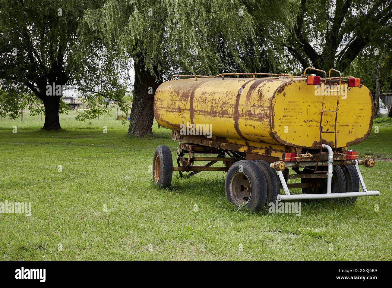 Large old yellow cart for transporting liquids on a field Stock Photo ...