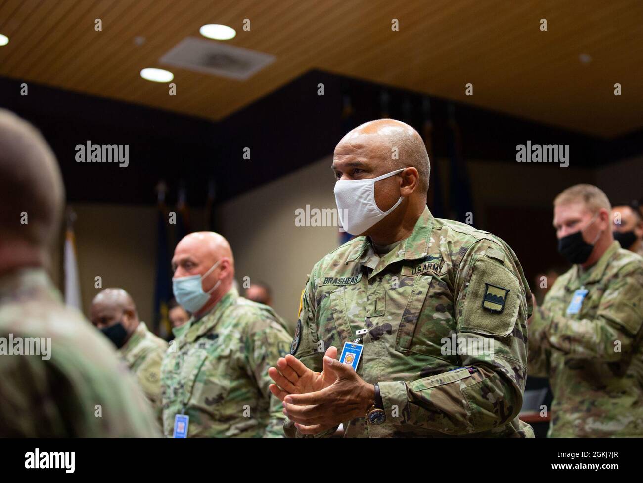 U.S. Army warrant officer applauds Retired U.S. Army Command Sgt. Maj. Frank M. Leota when he ...