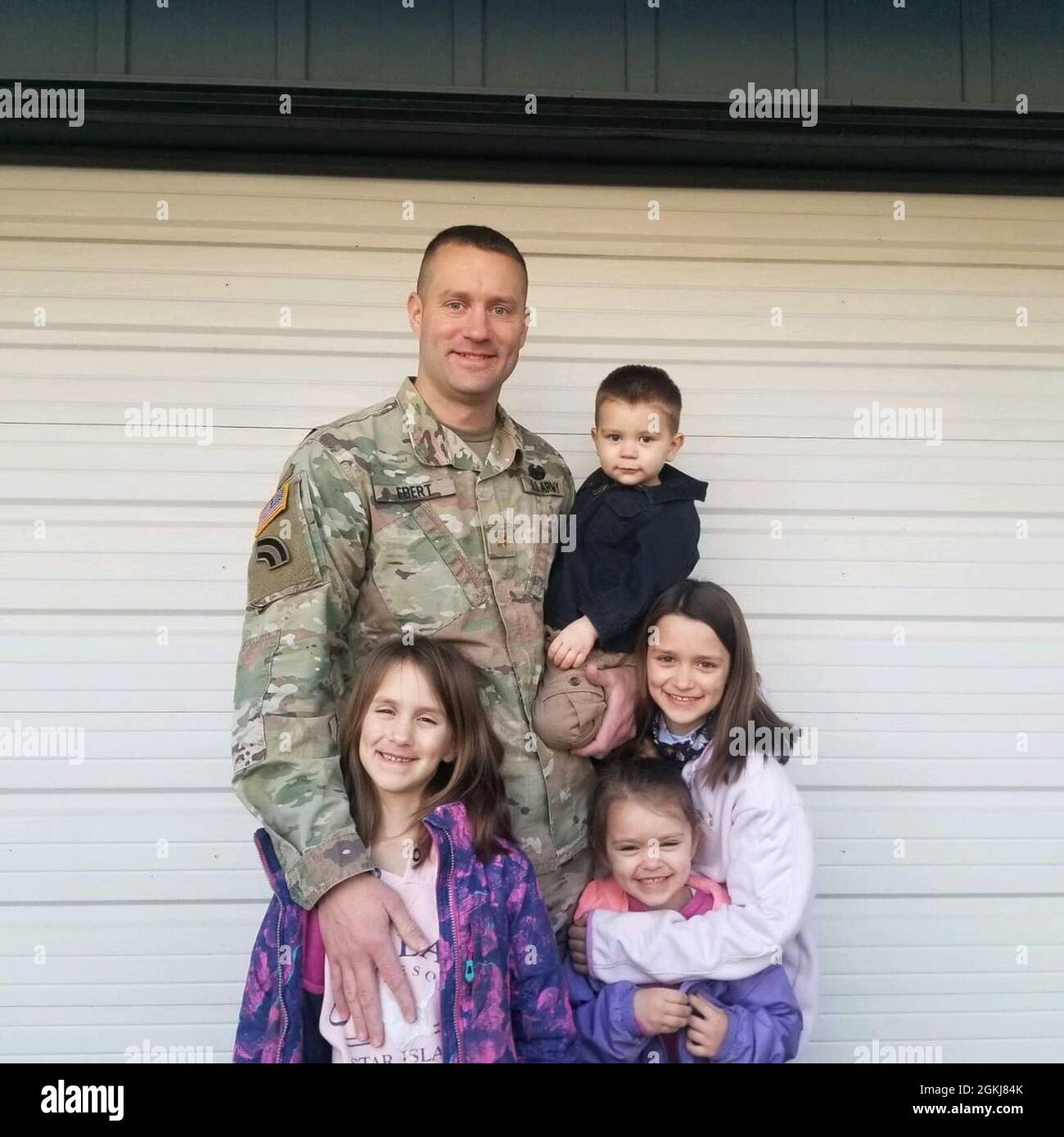 Andrew Ebert poses with his children before deploying with the 134 BSB ...