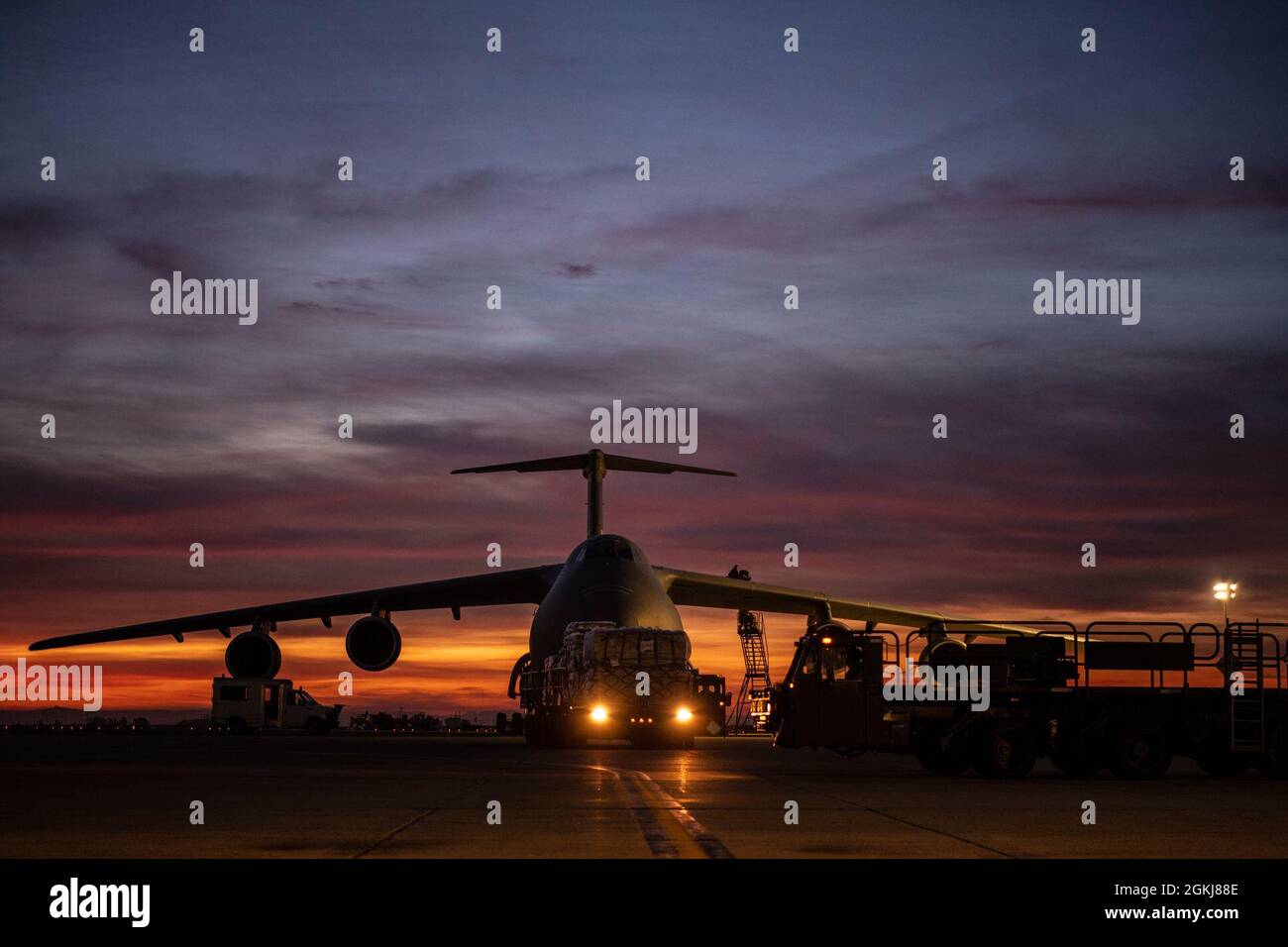 Airmen from the 60th Aerial Port Squadron load pallets holding ...