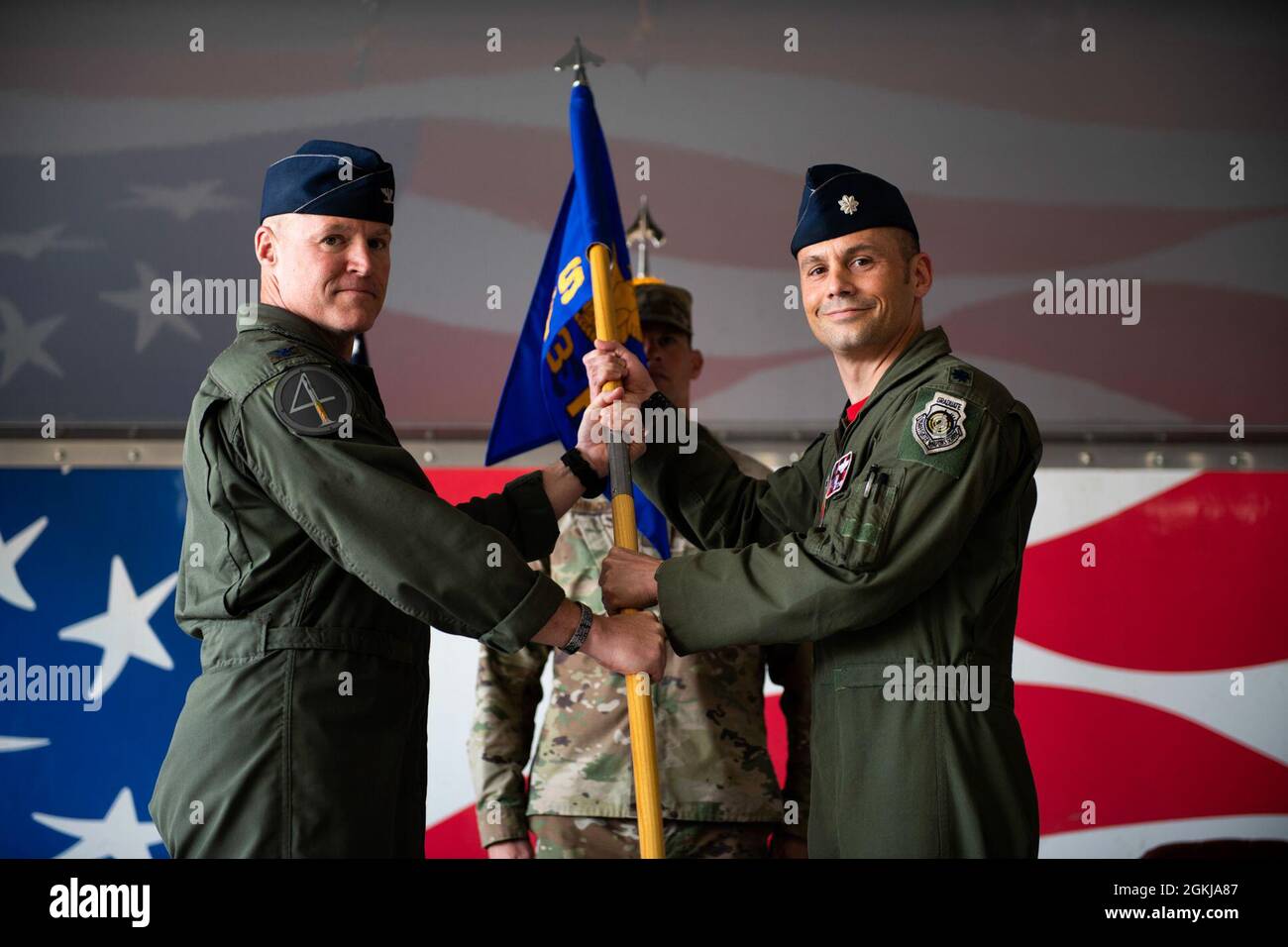 Lt. Col. Drew Bures, right, incoming 333rd Fighter Squadron commander ...
