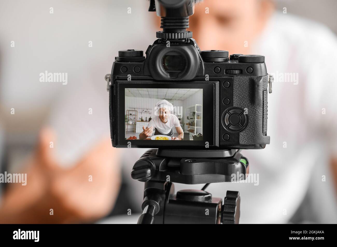 Italian chef with delicious pasta on display of photo camera in kitchen ...