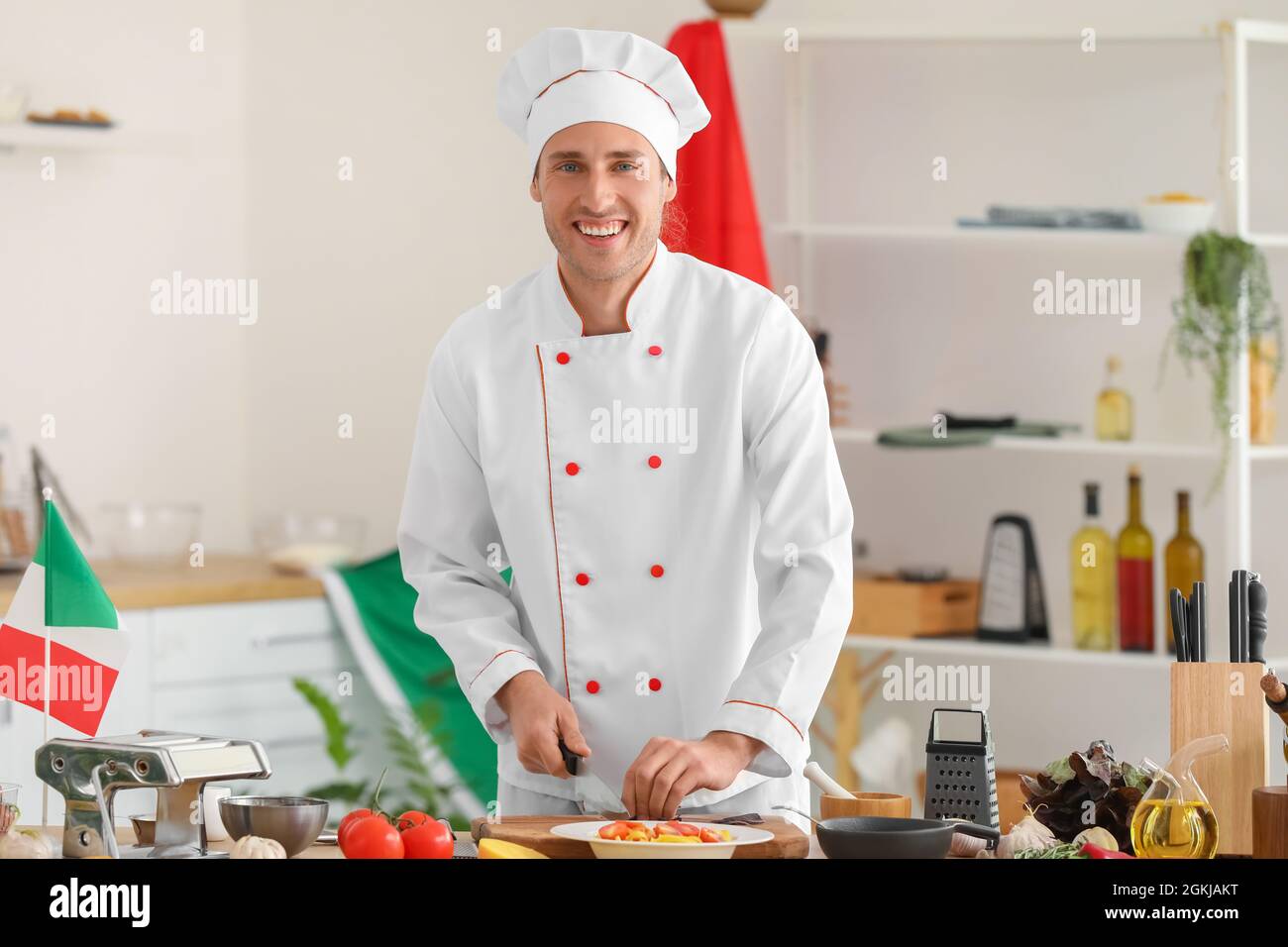 Italian chef cutting fresh basil in kitchen Stock Photo - Alamy