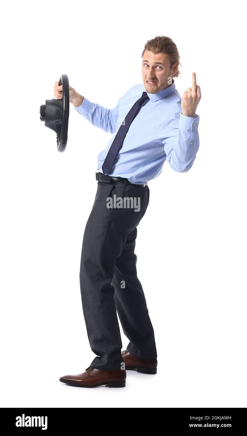 Young man with steering wheel showing middle finger on white background ...