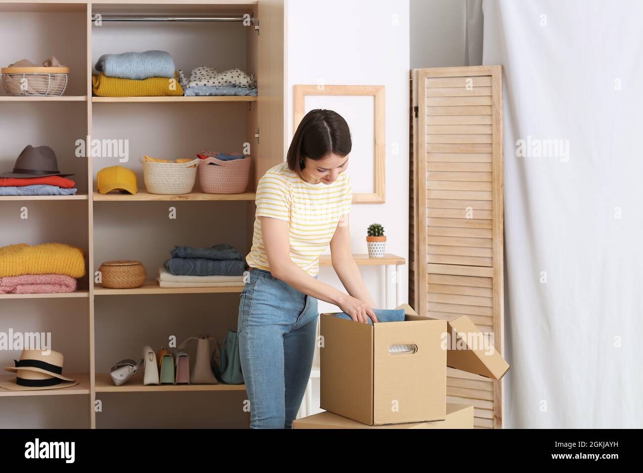 Woman arranging wardrobe hi-res stock photography and images - Alamy