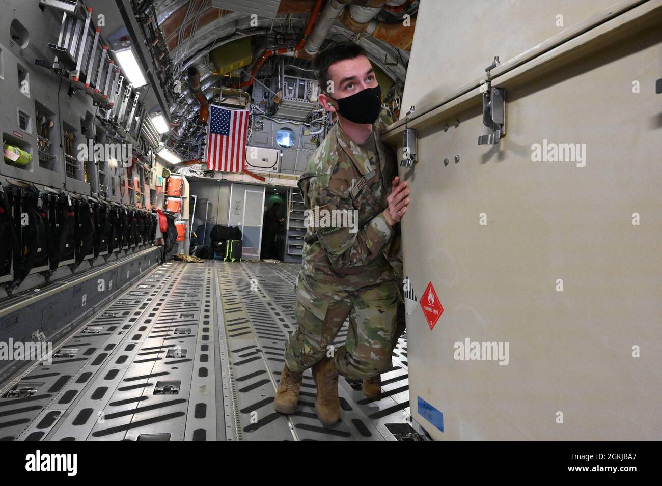 Airman Grayson Eback, of the 119th Logistics Readiness Squadron, pushes ...