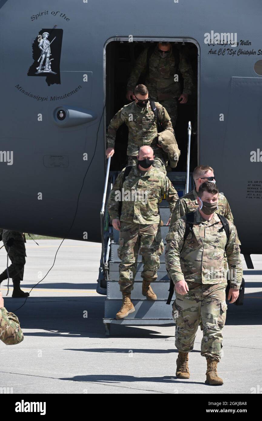 119th Wing members walk down the steps of a C-17 aircraft as they ...