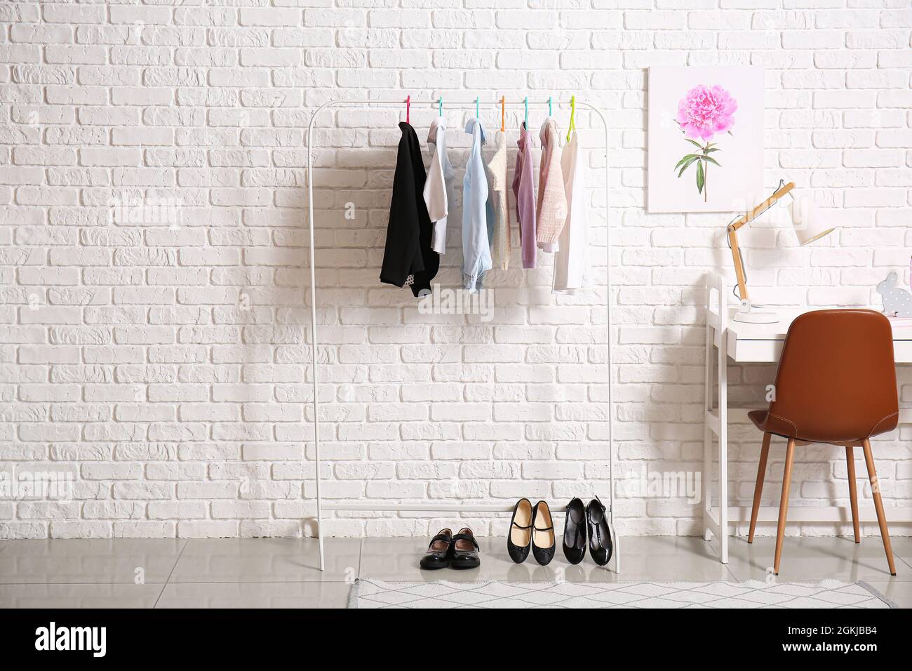 Rack with stylish school uniform in interior of room Stock Photo - Alamy
