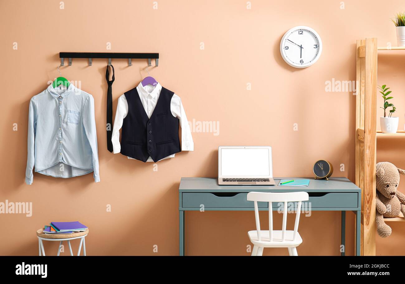 Interior of stylish room with modern workplace and school uniform Stock ...