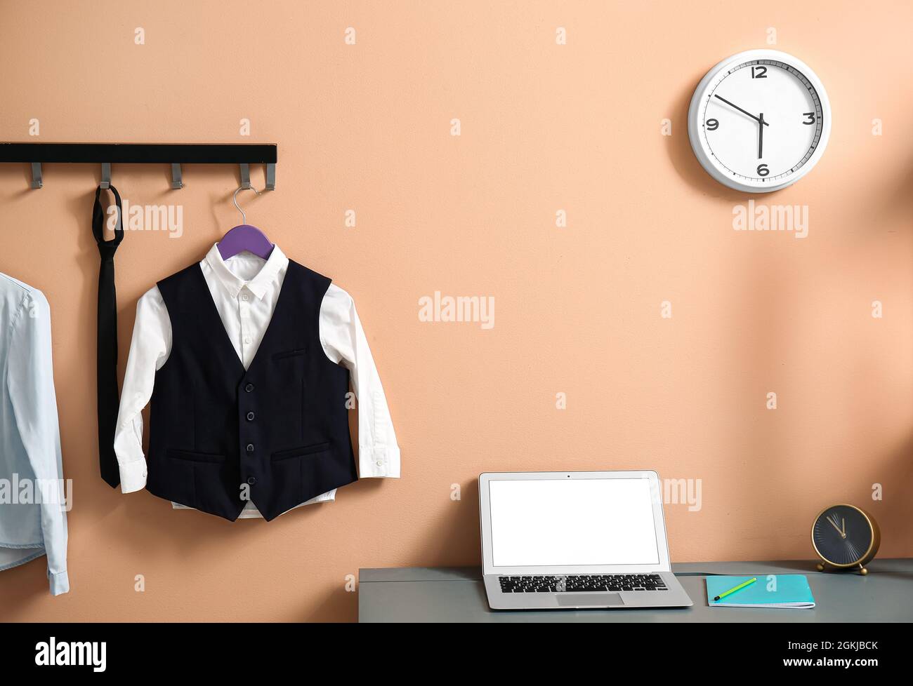 Interior of stylish room with school uniform and laptop on table Stock ...