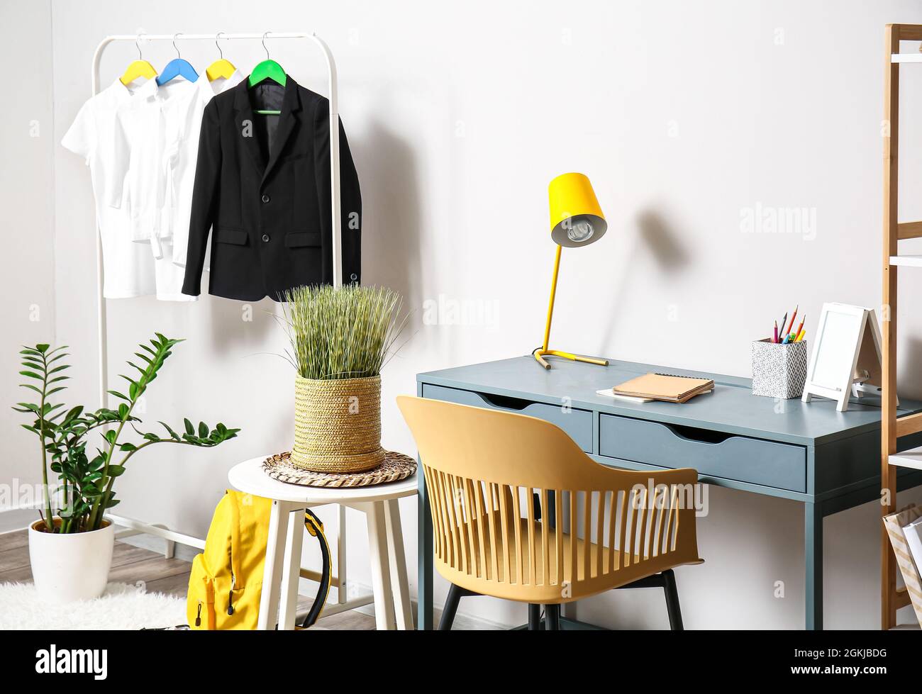 Interior of stylish room with modern workplace and school uniform Stock ...