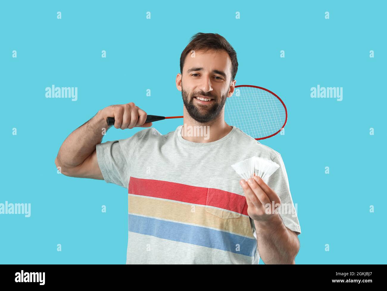 Sporty male badminton player on color background Stock Photo - Alamy