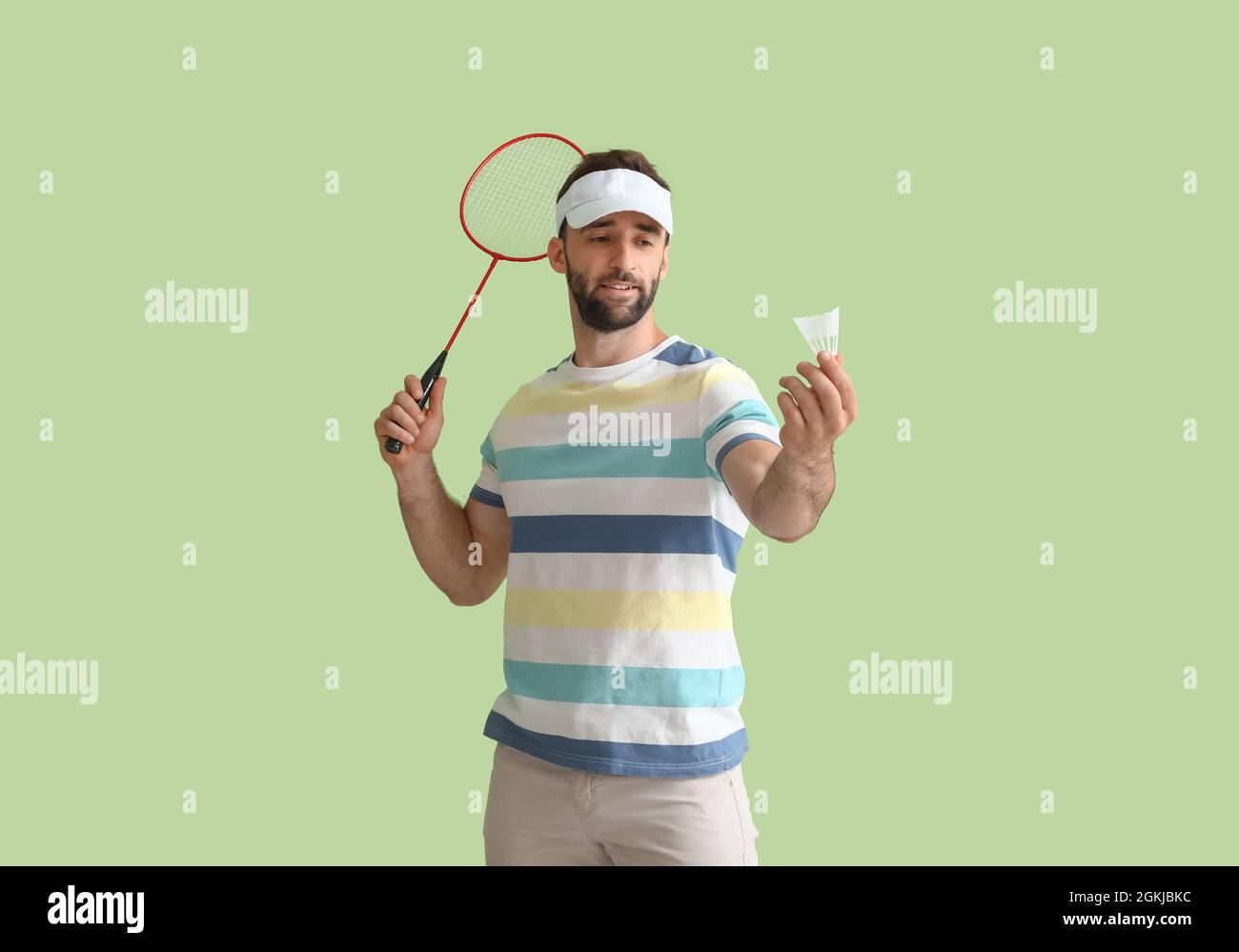 Sporty male badminton player on color background Stock Photo - Alamy