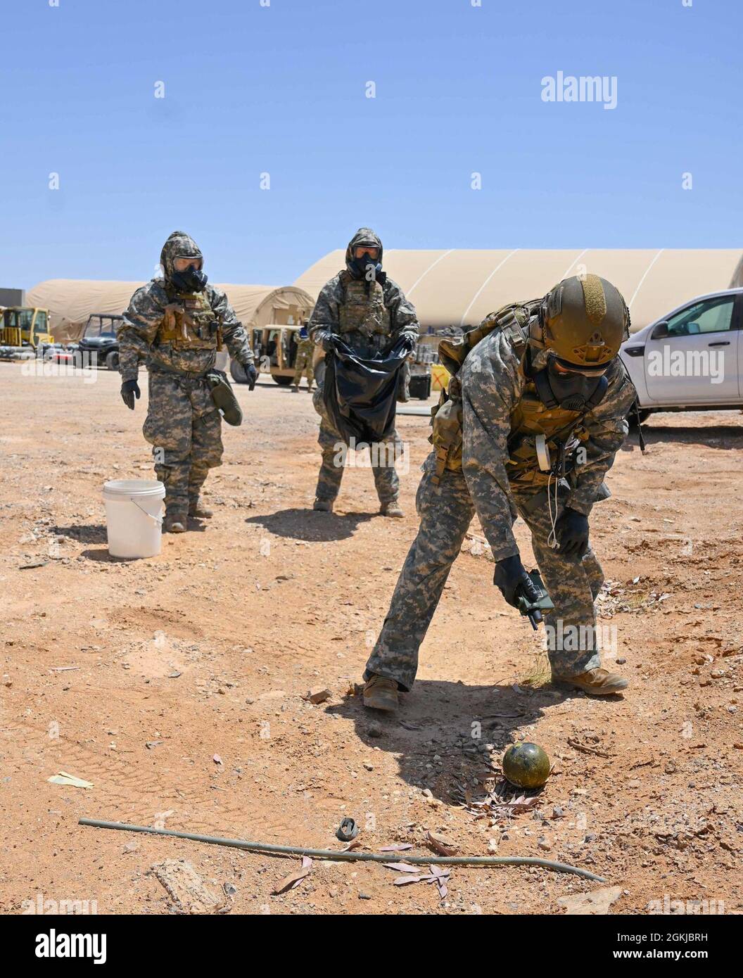 U.S. Air Force Staff Sgt. Wayne Walker, approaches a simulated UXO or ...