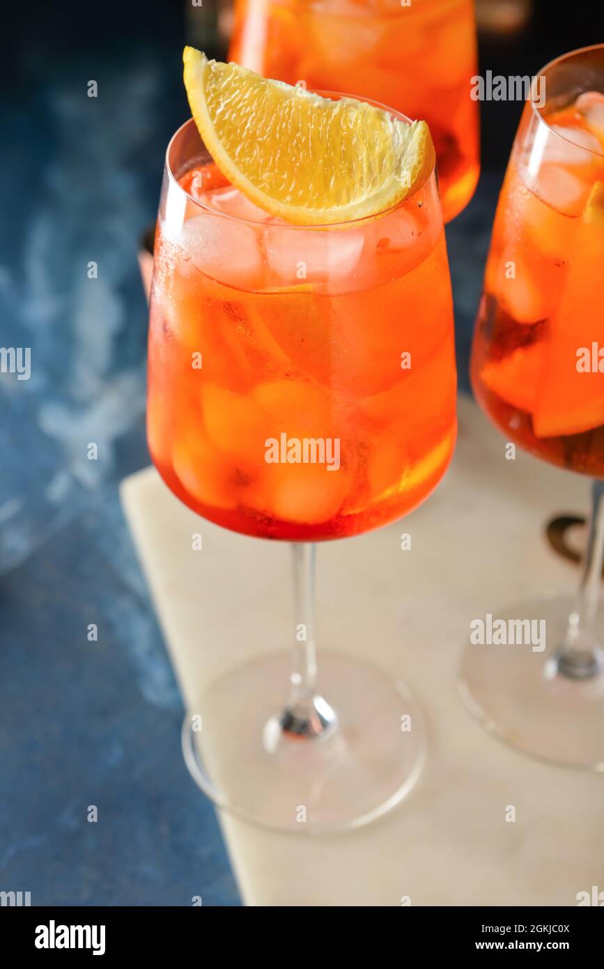 Glasses of tasty aperol spritz cocktail on color background Stock Photo ...