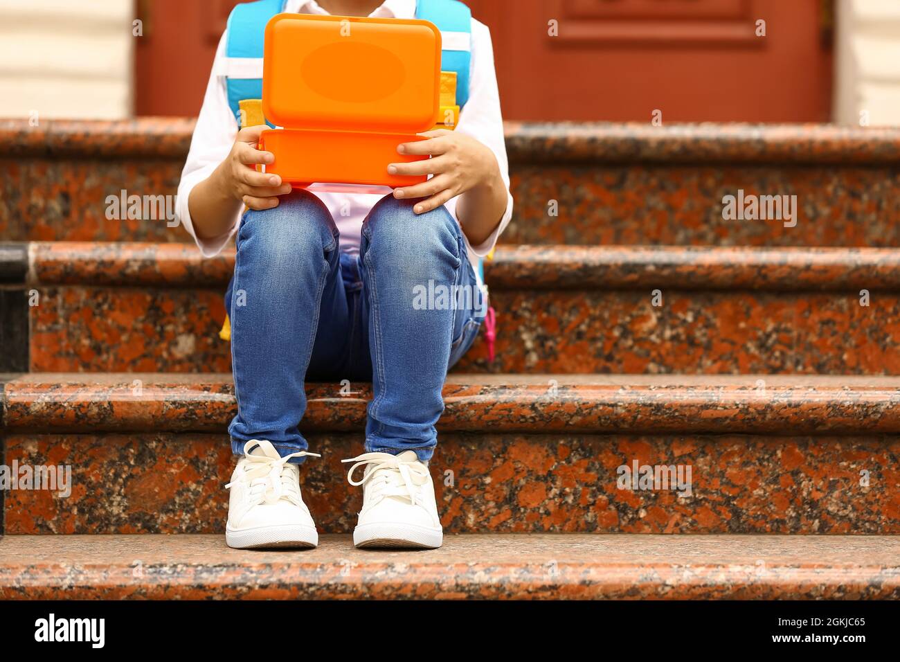 Cute little girl having school lunch outdoors Stock Photo - Alamy