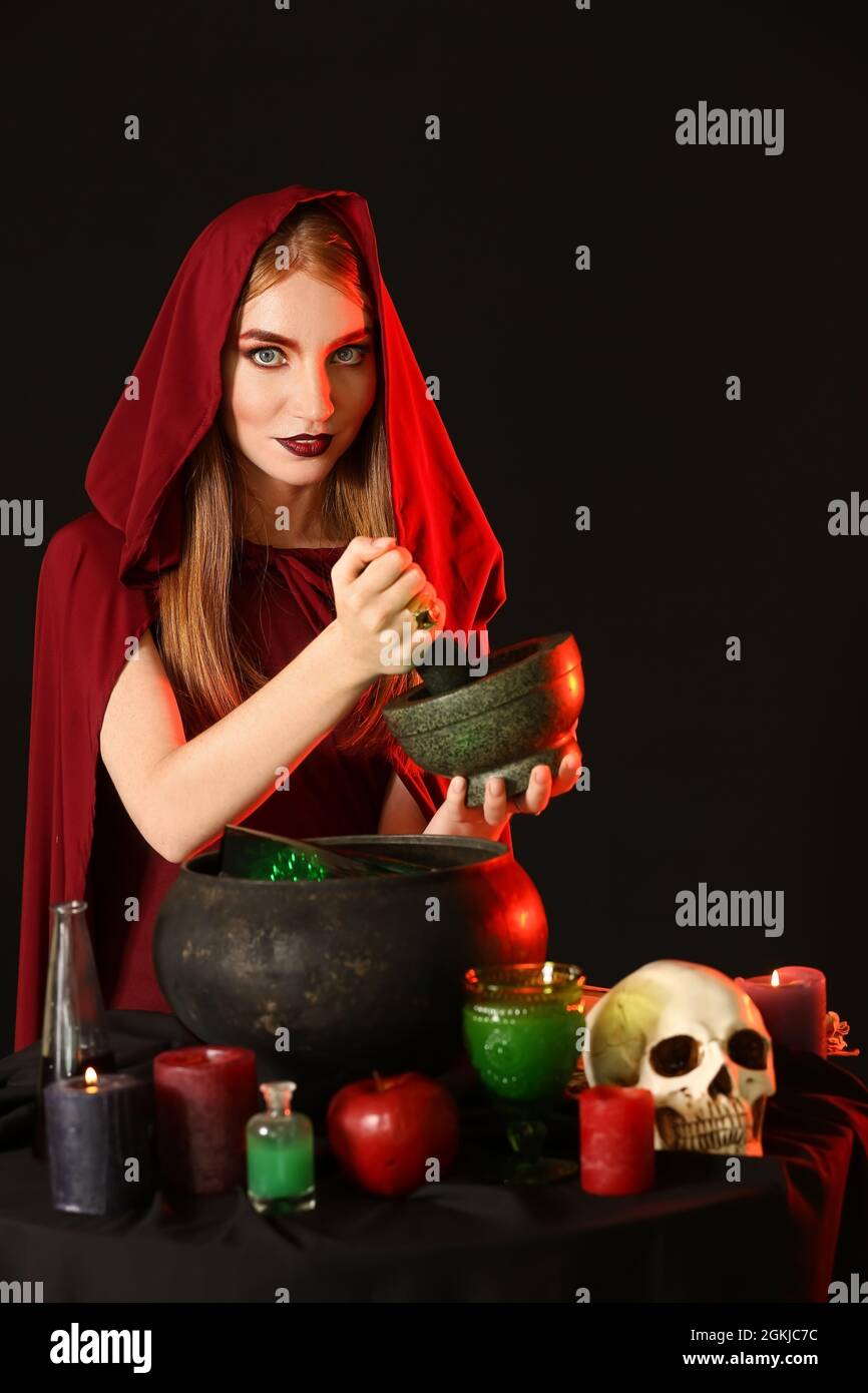 Witch performing ritual on dark background Stock Photo - Alamy