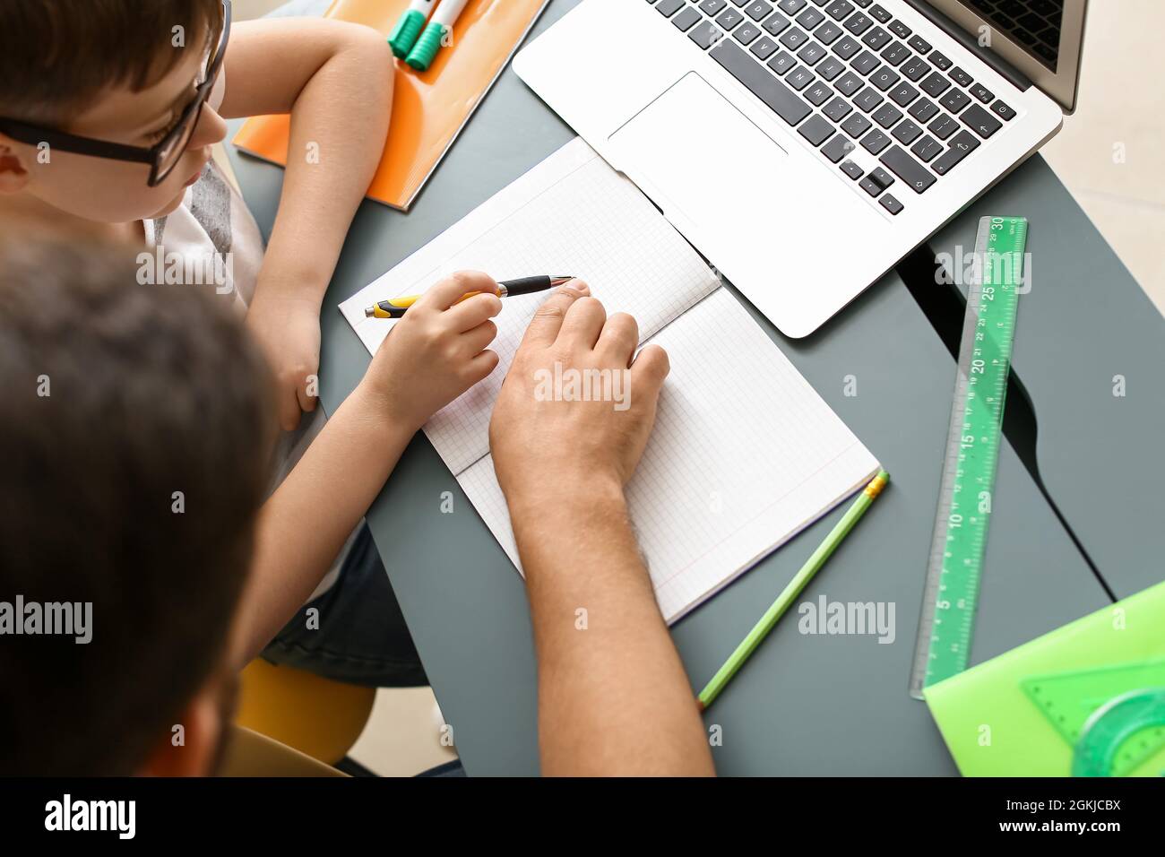 Little boy with his father doing lessons at home Stock Photo - Alamy