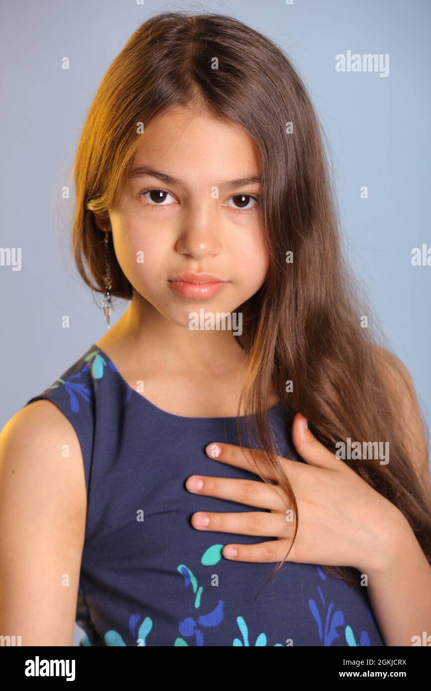Close-up portrait with hand near face. The portrait shows a beautiful ...
