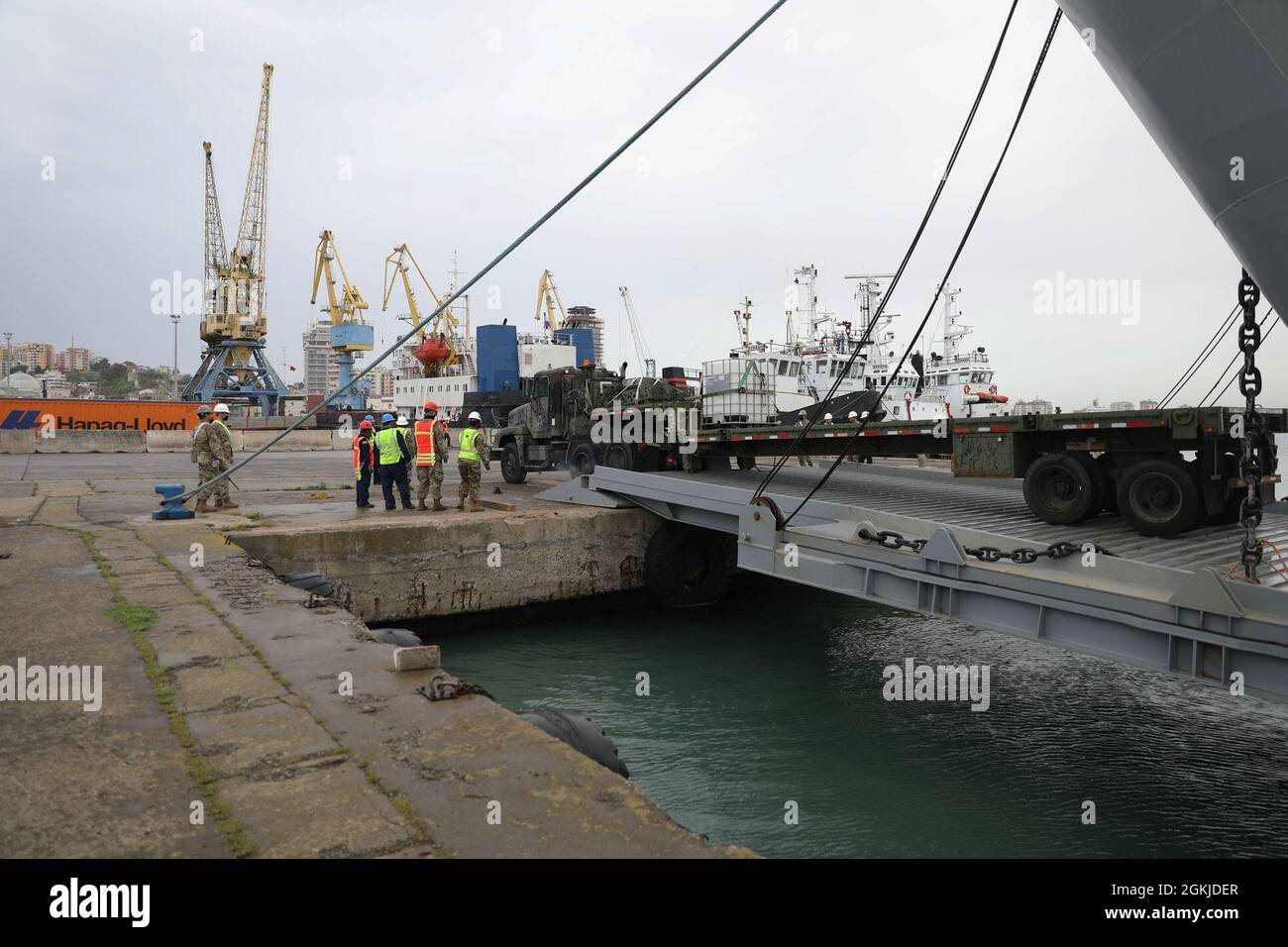 U.S. military personnel stand on the dock at Durres Port watching ...