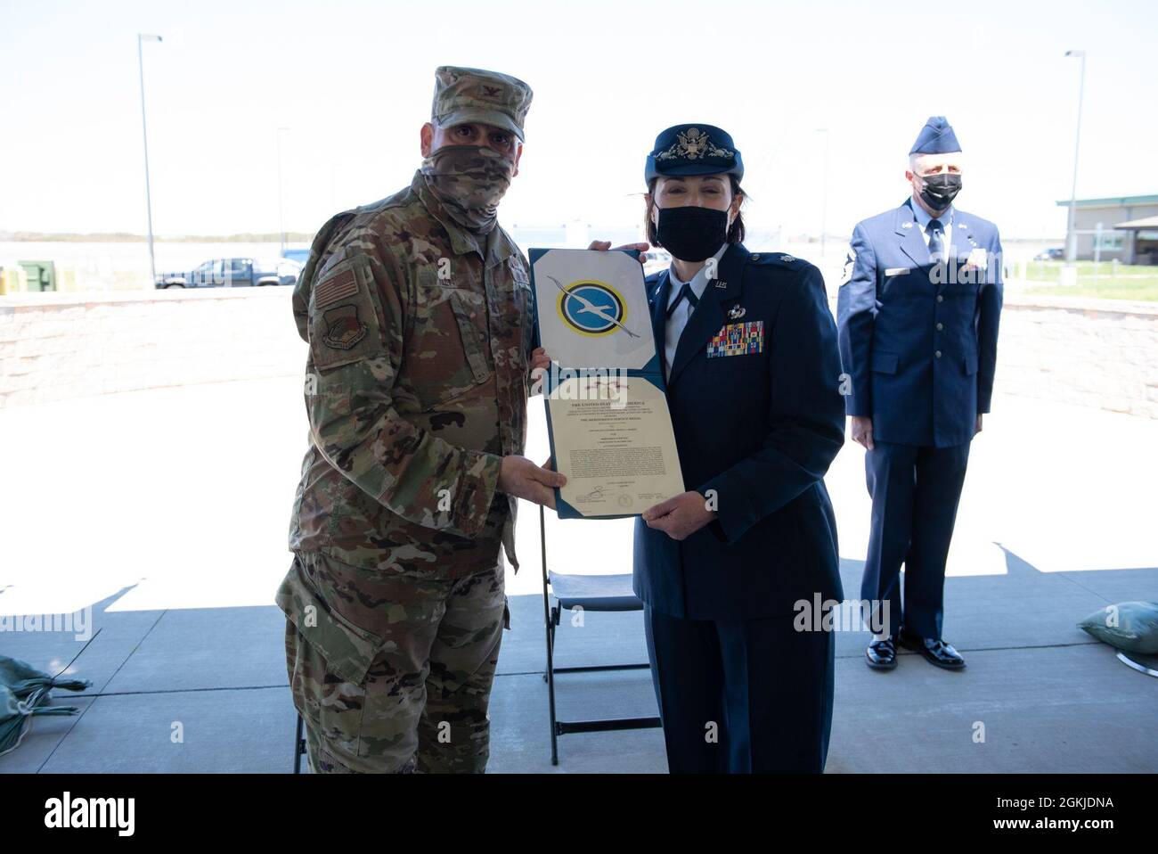 Col. Sean Riley, 102nd Intelligence Wing Commander, hands the ...