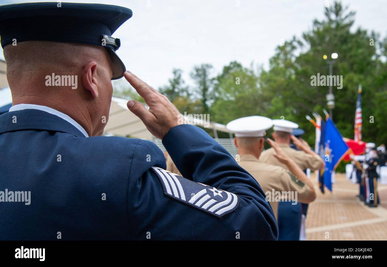 A chief master sergeant salutes during the National Anthem at the 52nd ...