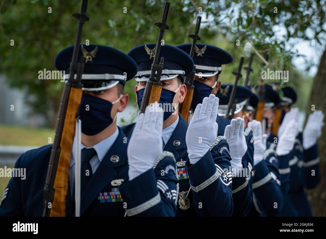Air Force honor guard members prepare for a rifle volley at the end of ...