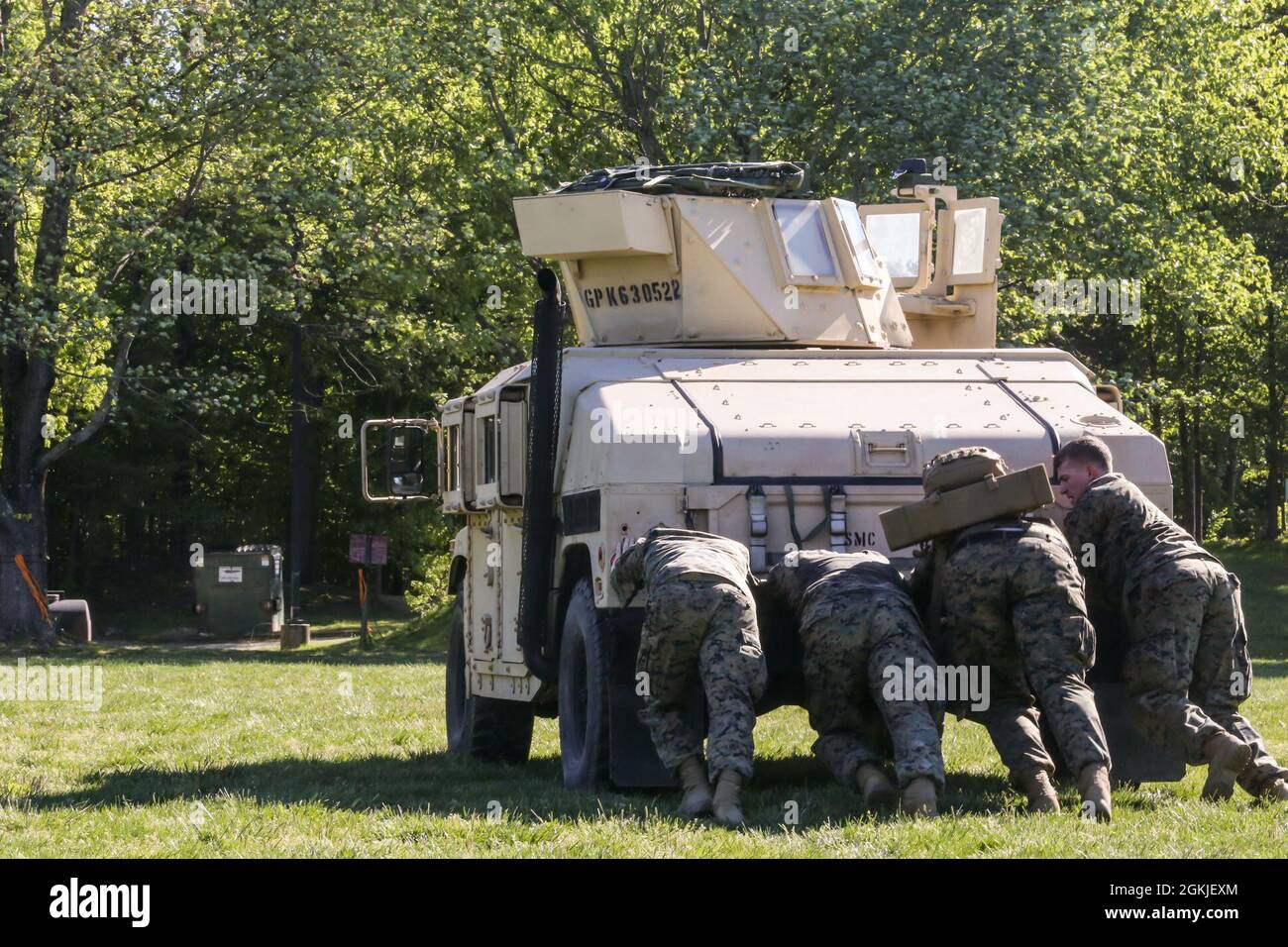 U.S. Marines with The Basic School push a Humvee while competing in the ...
