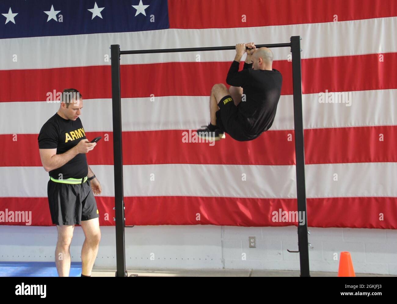 Master Fitness Trainer Sgt. 1st Class Codey Fischer, left, explains the ...