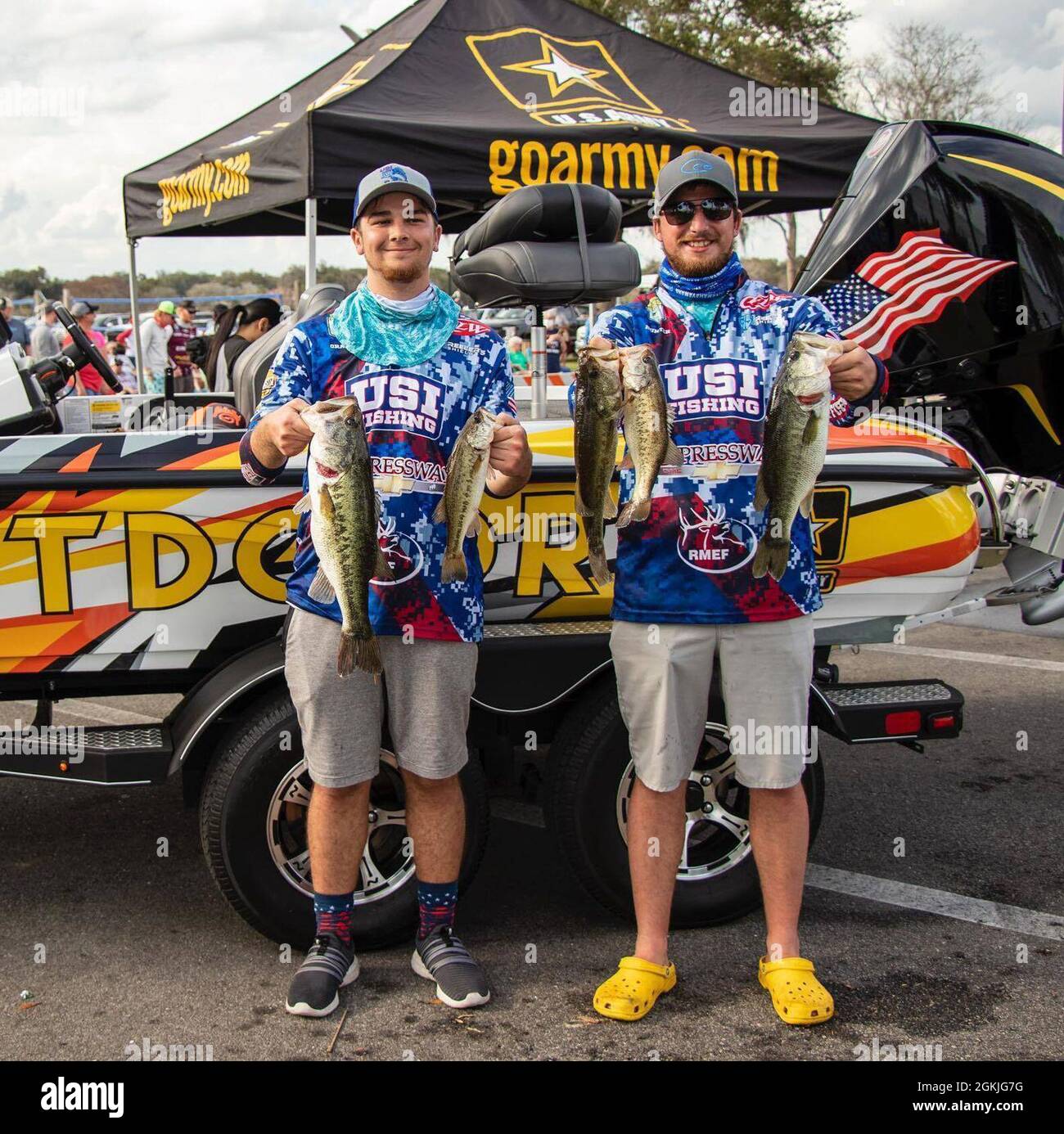 Anglers at a recent event showcase their catch in front of the Army’s ...