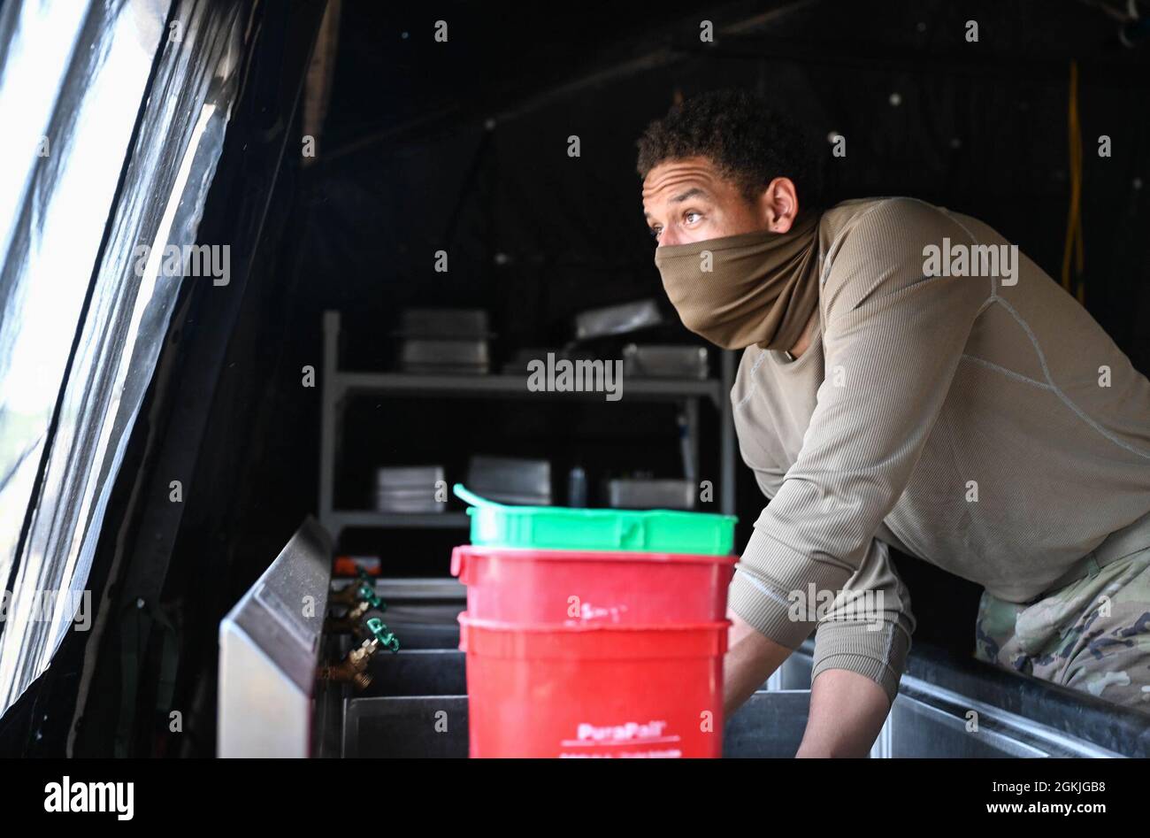 A U.S. Air Force Airman cleans and sanitizes the chow tent at Naval ...