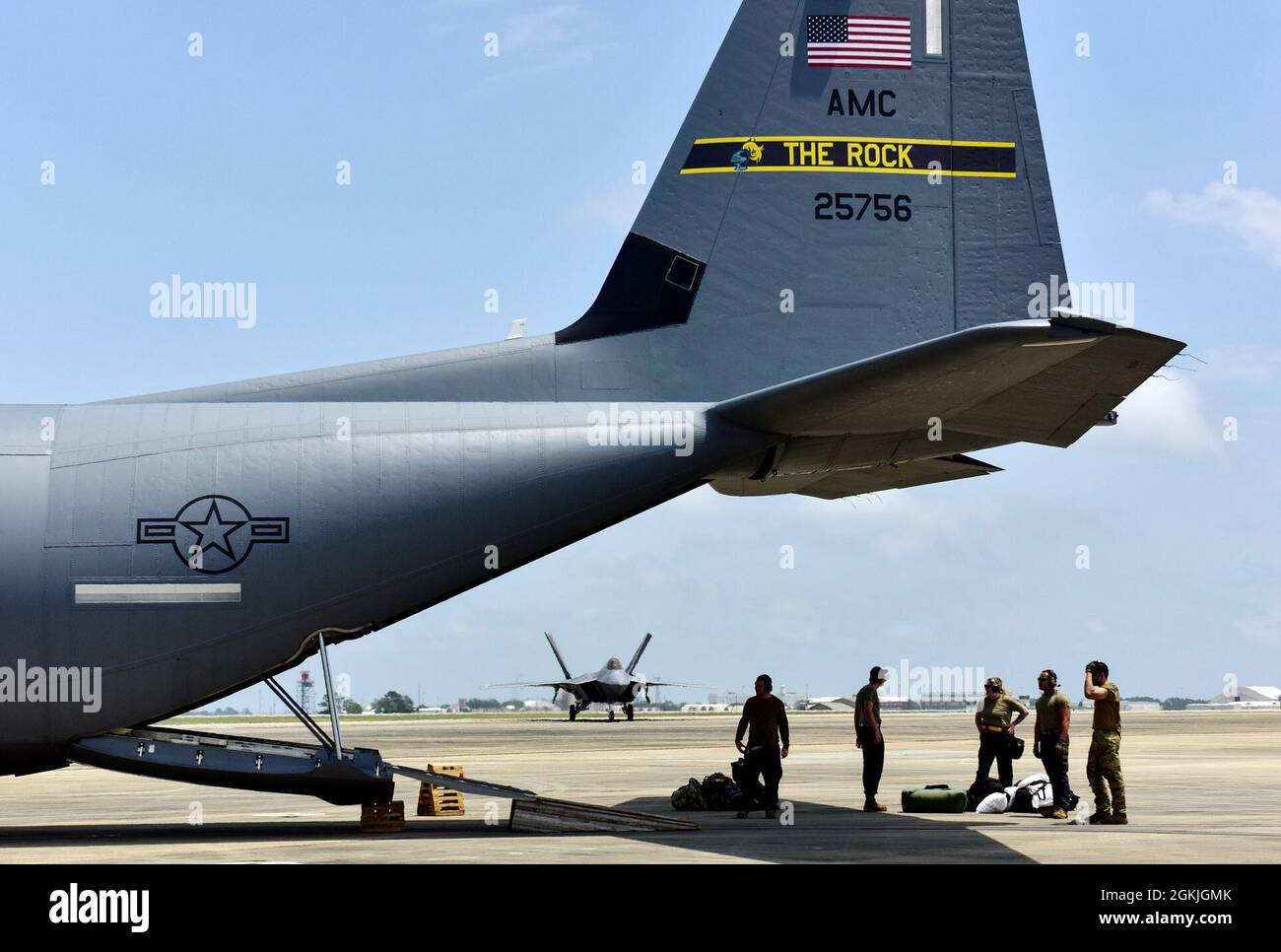 Airmen assigned to the 19th Airlift Wing offload cargo from a C-130J ...